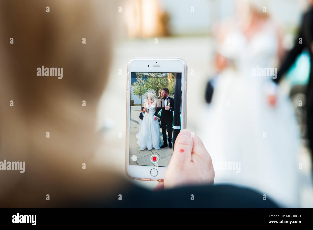 Photo of bride and groom on a smartphone Stock Photo - Alamy