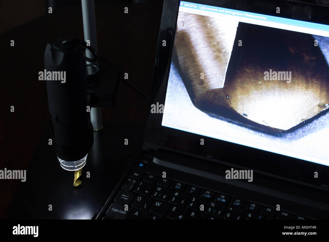On the left is the drill under the microscope which is illuminated by ...