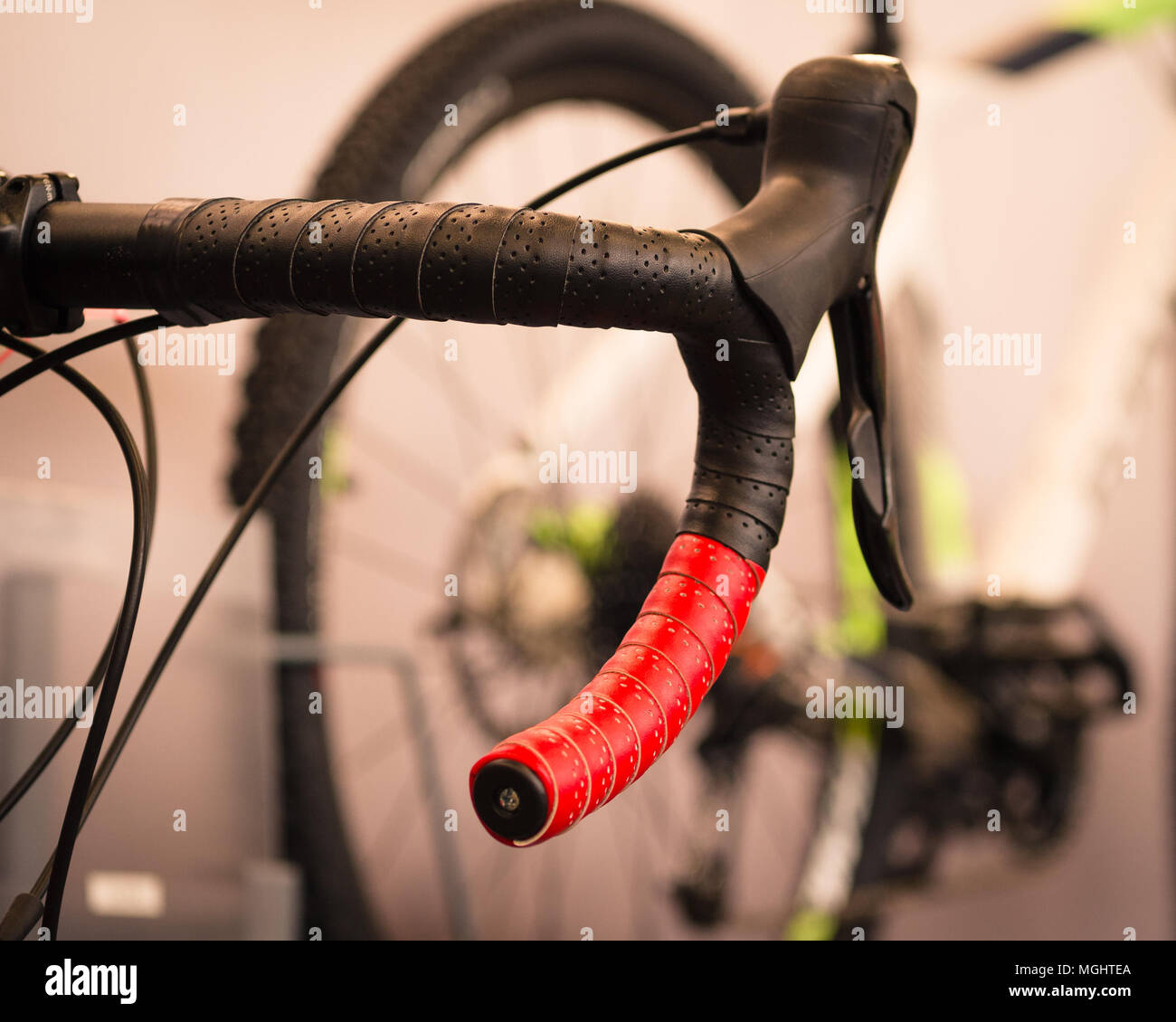 Detail of the red handlebar of a racing bike before the start of a race ...