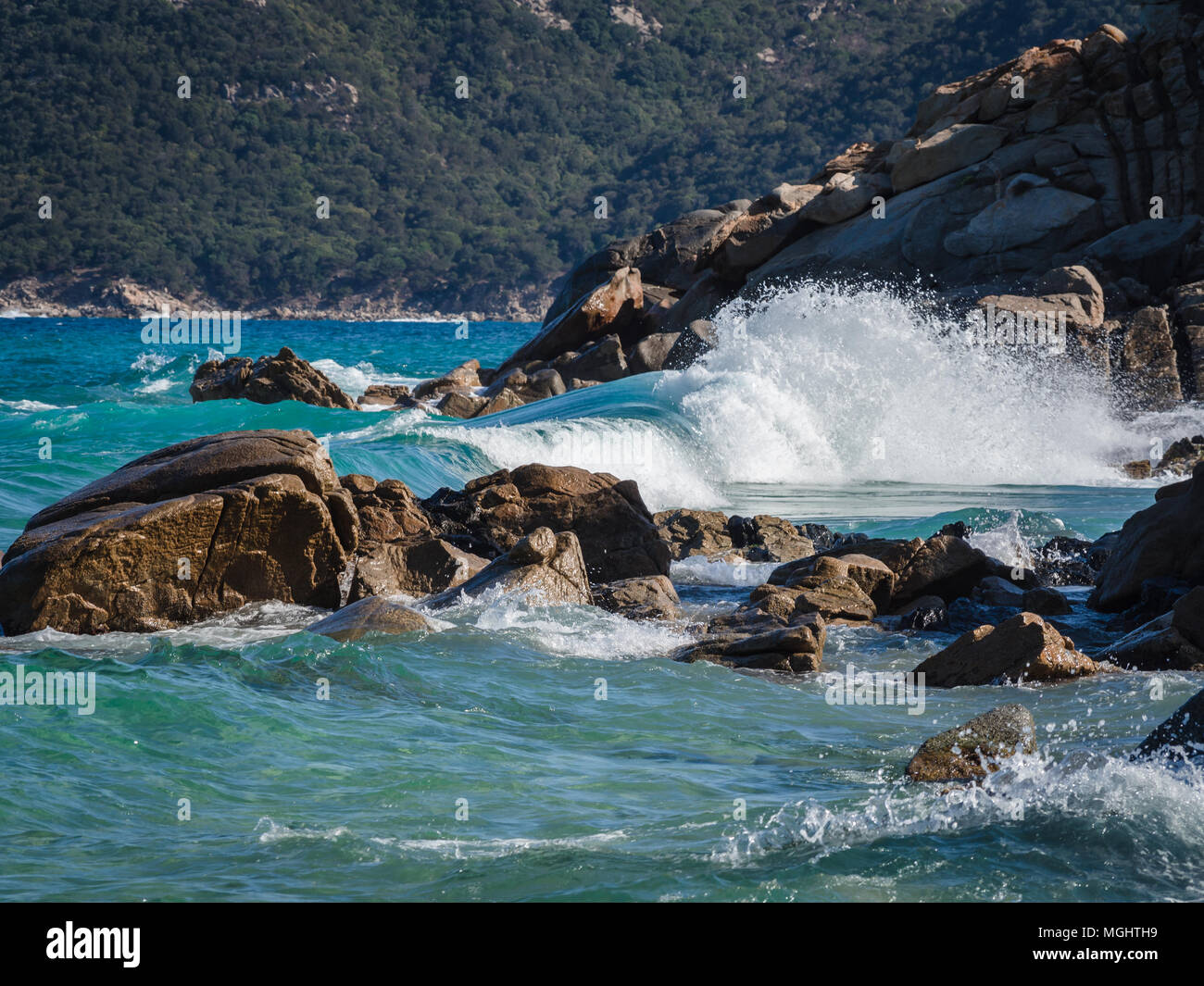 Detail of a wave breaking on the rocks Stock Photo - Alamy