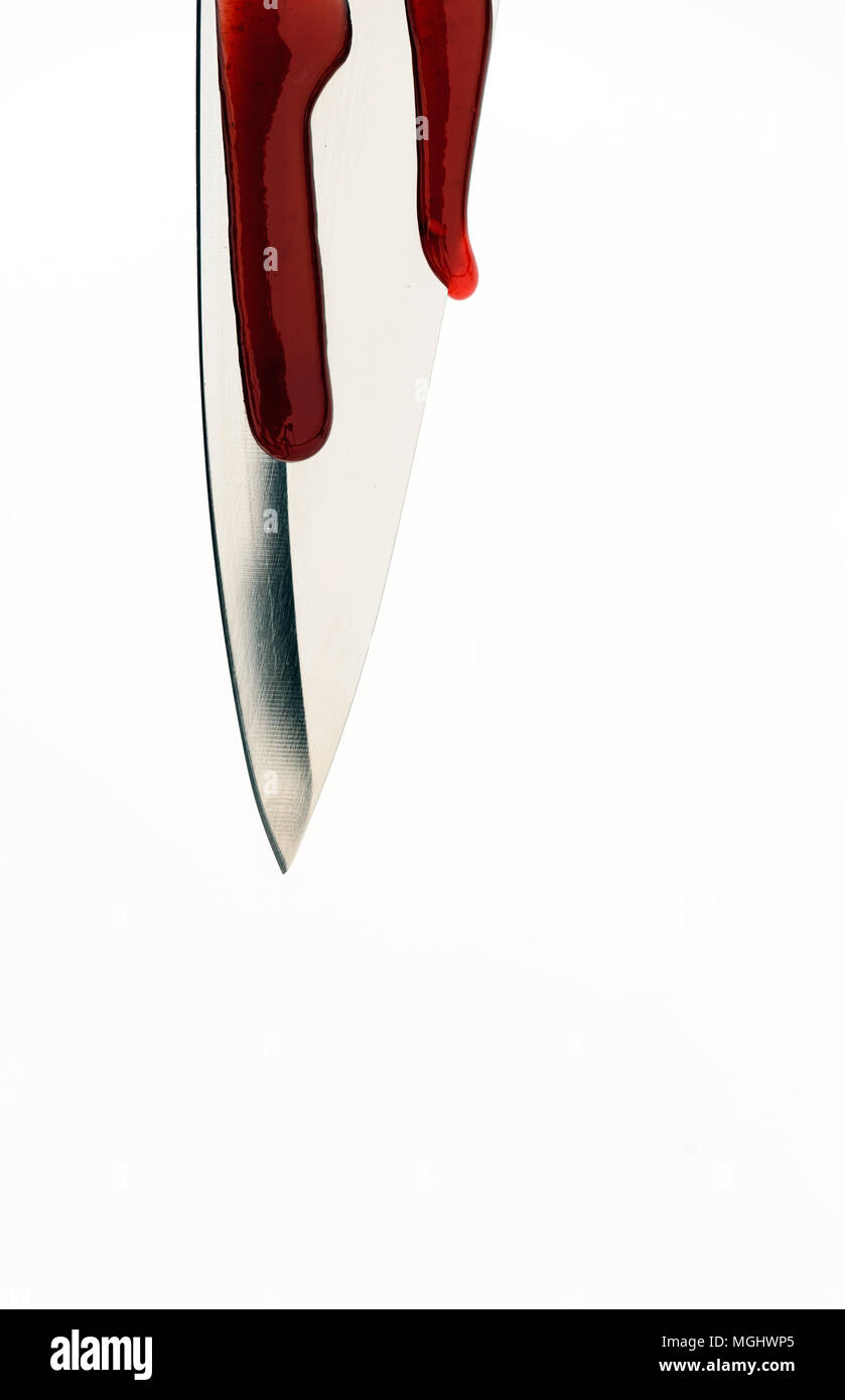 Single sharp silver knife edge in macro closeup with red blood droplets ...