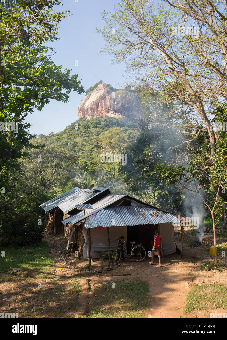 View of houses with Sigiriya Rock Fortress in background, Central ...