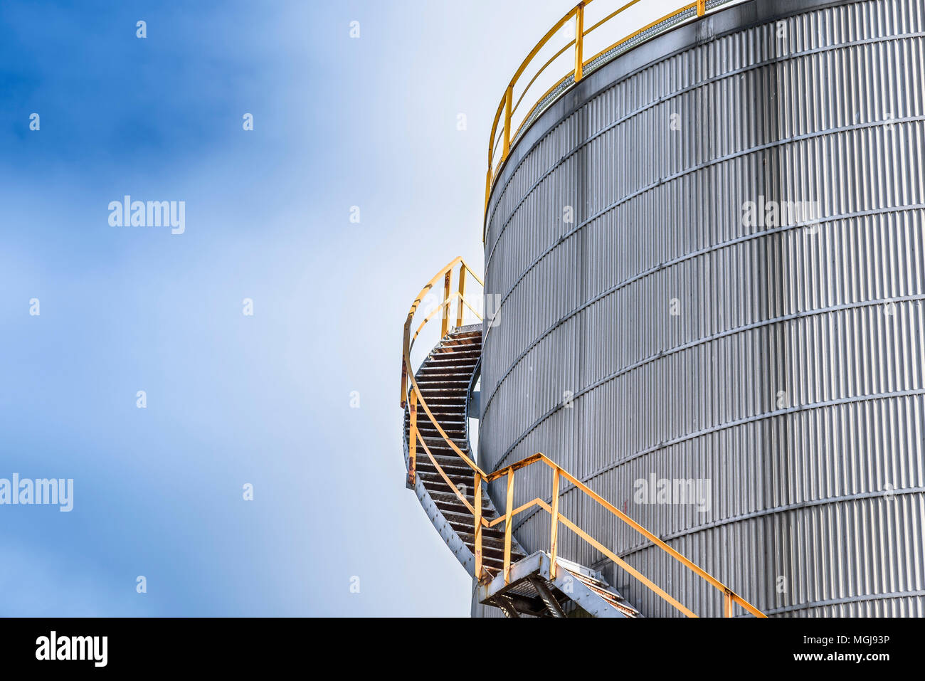 Industrial chemical tank with spiral stairway Stock Photo - Alamy