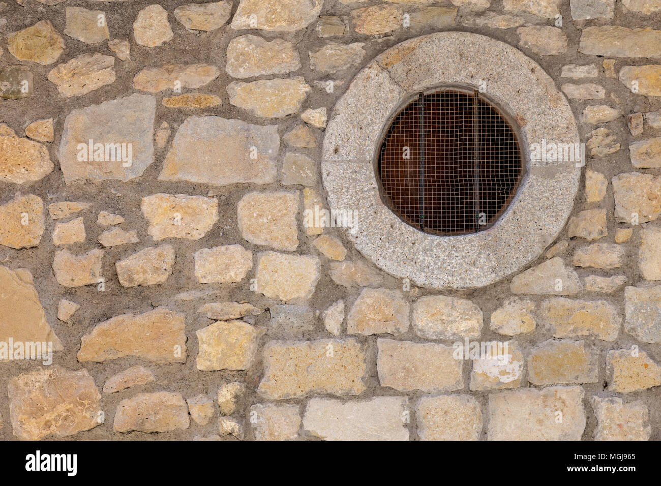 The circle window on stone wall, for background Stock Photo - Alamy