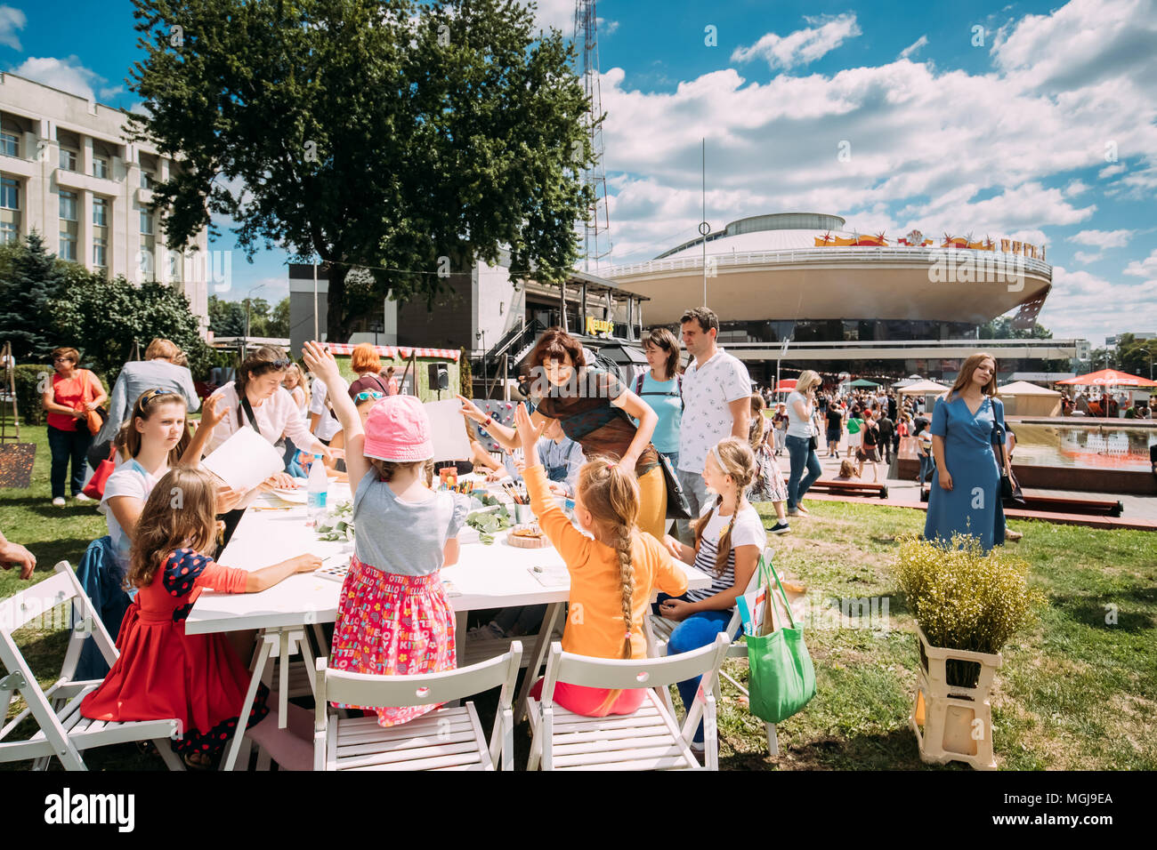 Gomel, Belarus. Children With Parents Draw At Street In Summer Sunny ...