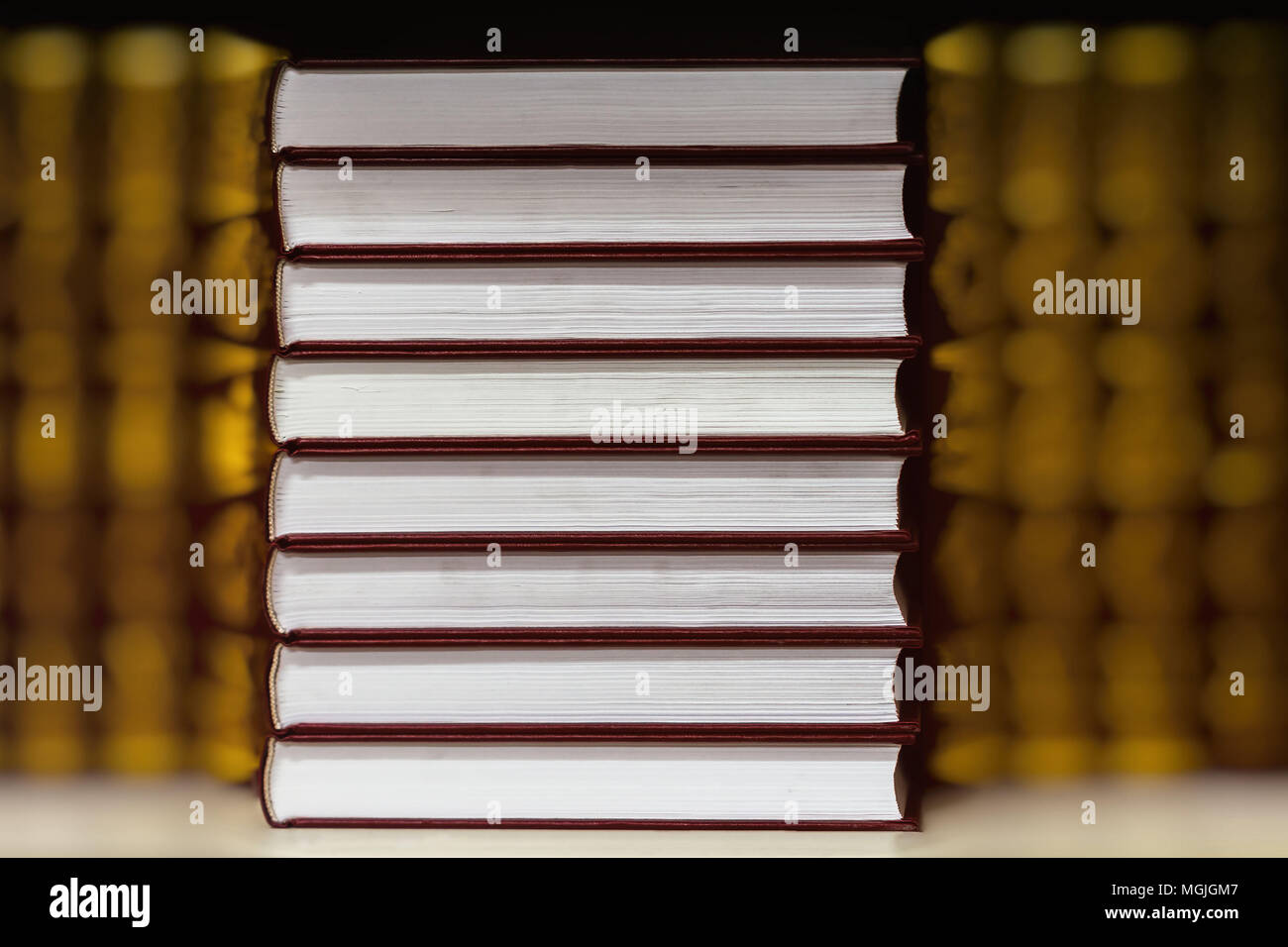 Abstract blurred background of Heap of closed books in hard covers on a ...