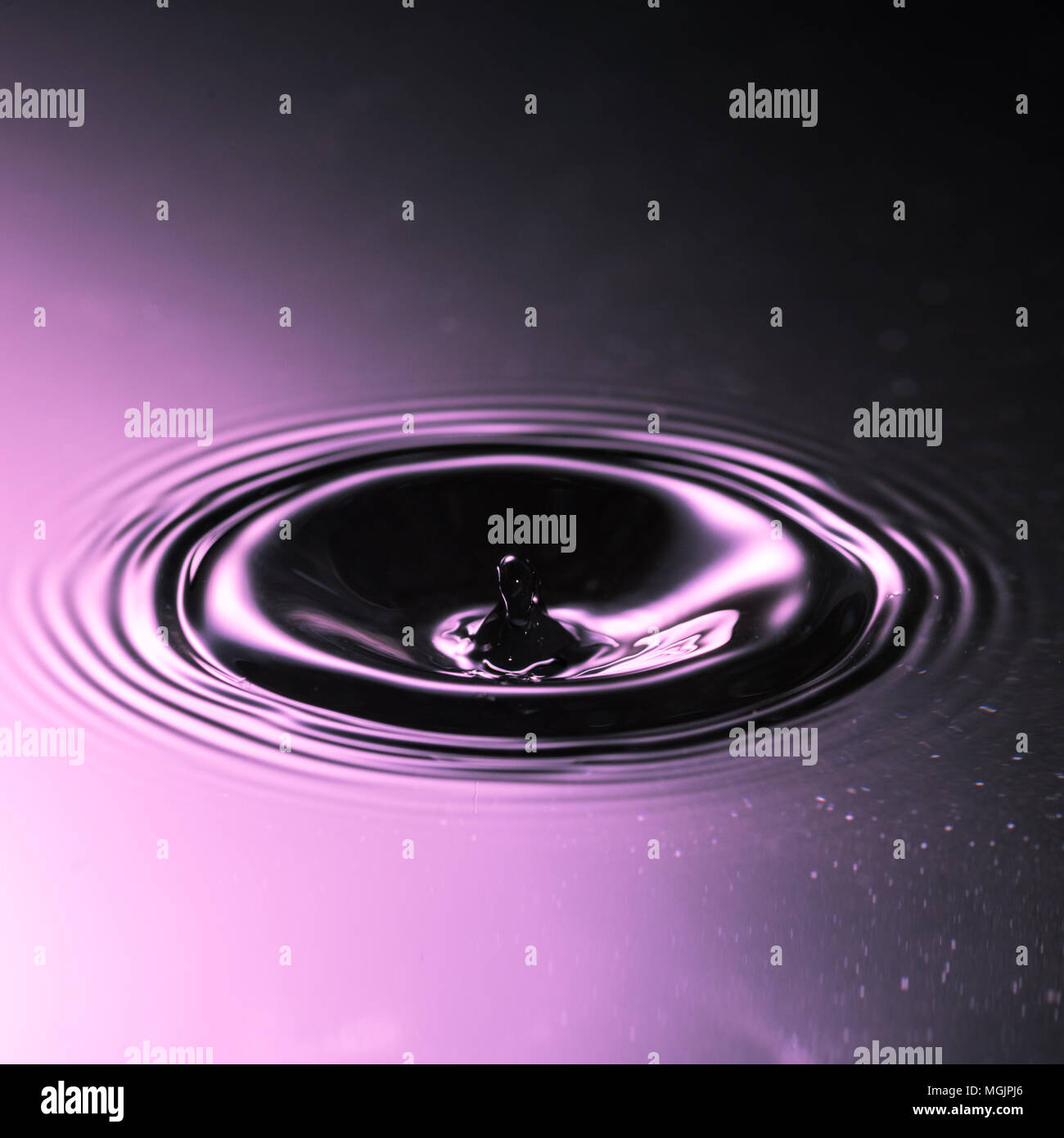 Ripples spread out from a water drop falling into some water Stock ...