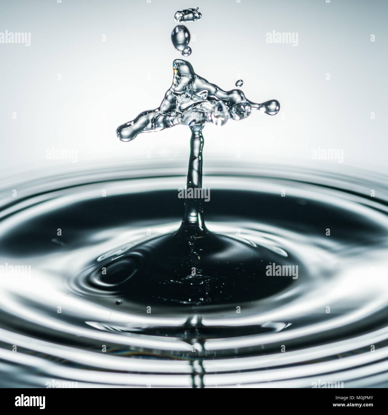 An abstract macro shot of a water splash that looks like a spinning top ...