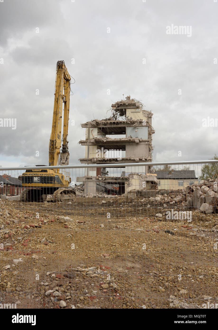 Safety barrier protecting demolition site with partly demolished ...