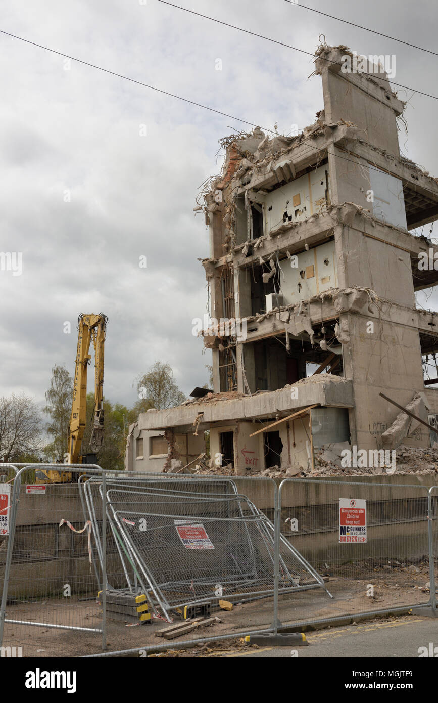 Controlled demolition of multi storey building with safety fencing and ...