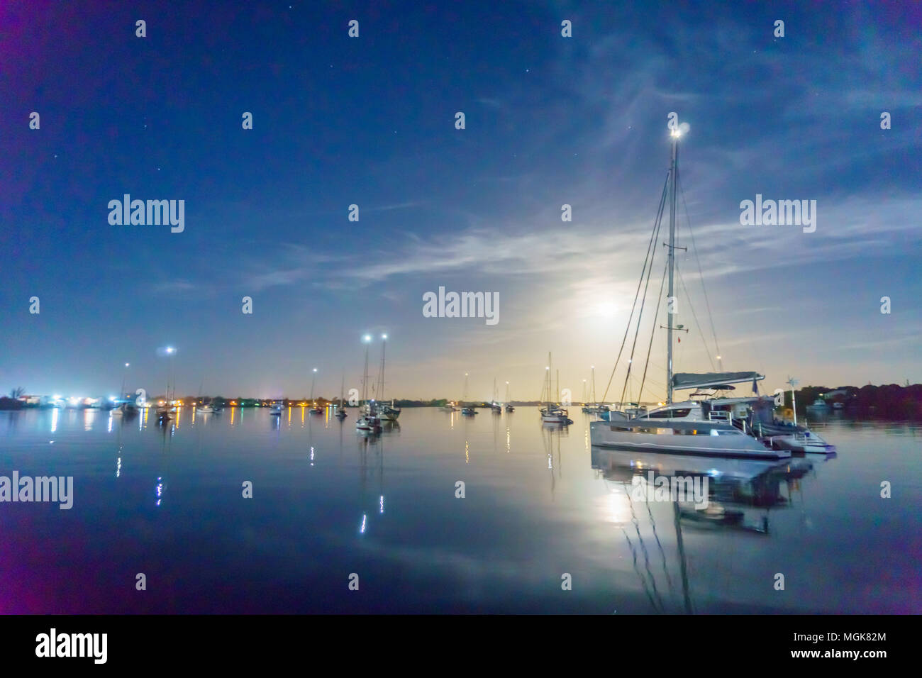 Sailboats and Charter Catamarans anchored in a mirror smooth anchorage ...