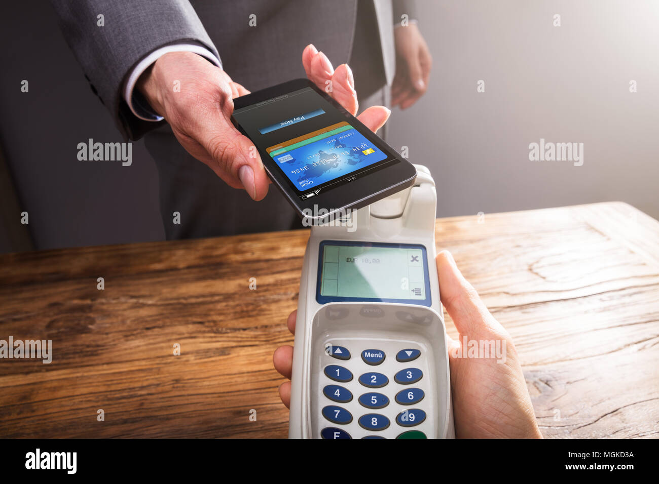 Close-up Of A Businessperson's Hand Paying With Smartphone Using NFC ...