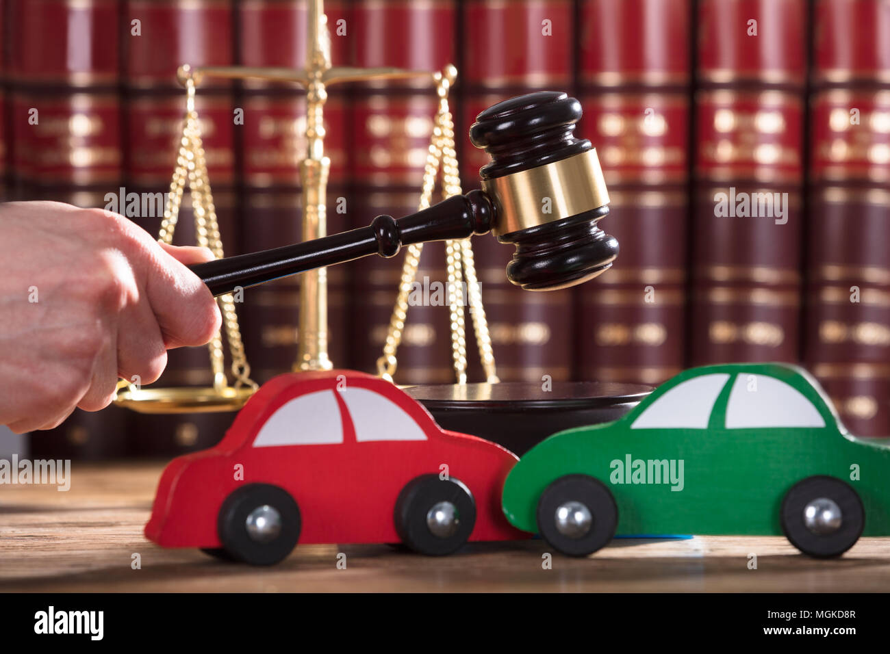 Close-up Of A Judge Holding Mallet Over Green And Red Car Stock Photo ...