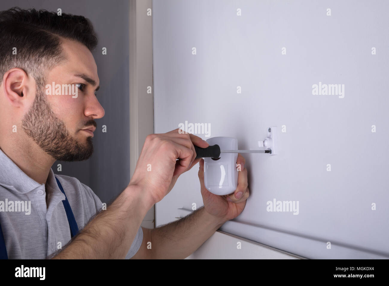 Close-up Of A Young Male Electrician Installing Security System Door ...