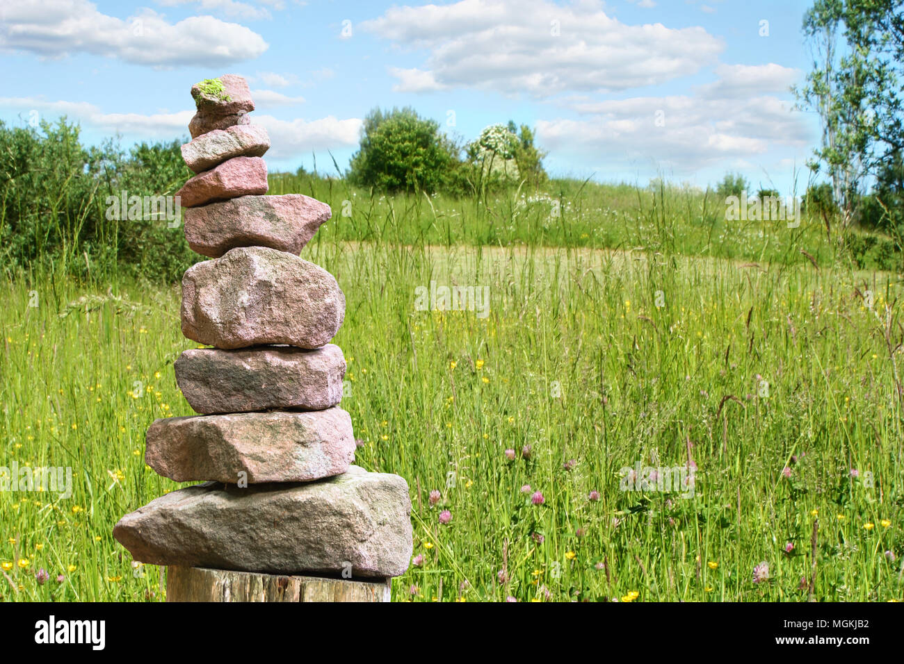 Stacked stone pyramid from sandstone as a sign for awareness on a juicy ...