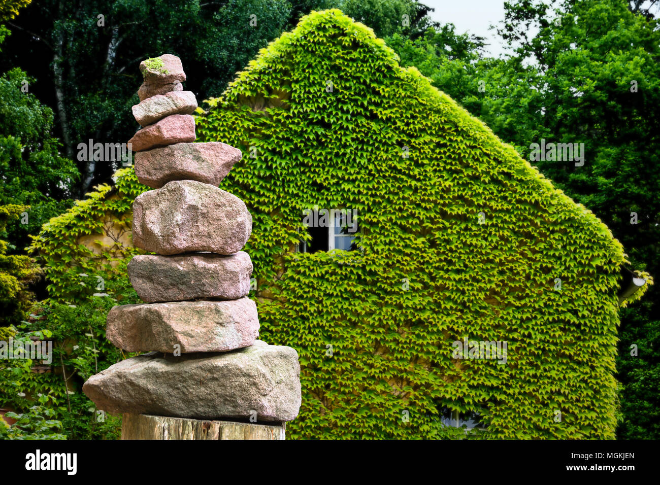 Stacked stone pyramid from sandstone in front of an eco house Stock ...