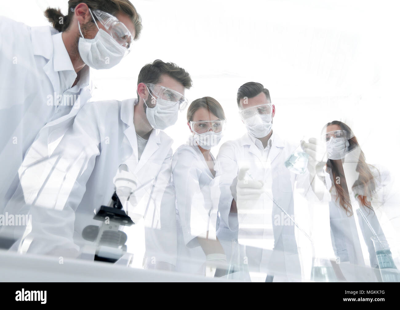 scientists working with test tubes and microscope in the laboratory ...