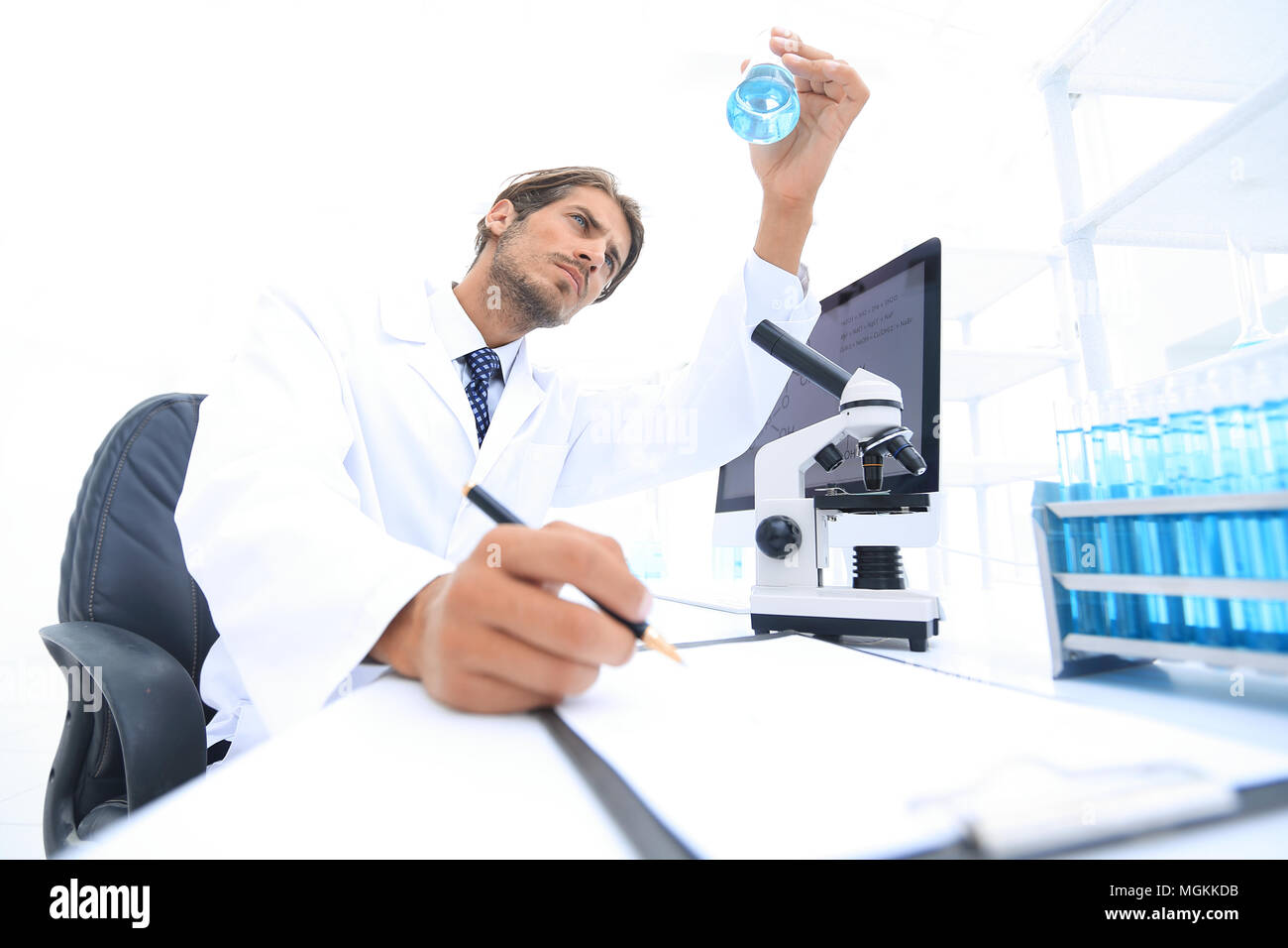 scientist analyzing an experiment in a laboratory Stock Photo - Alamy