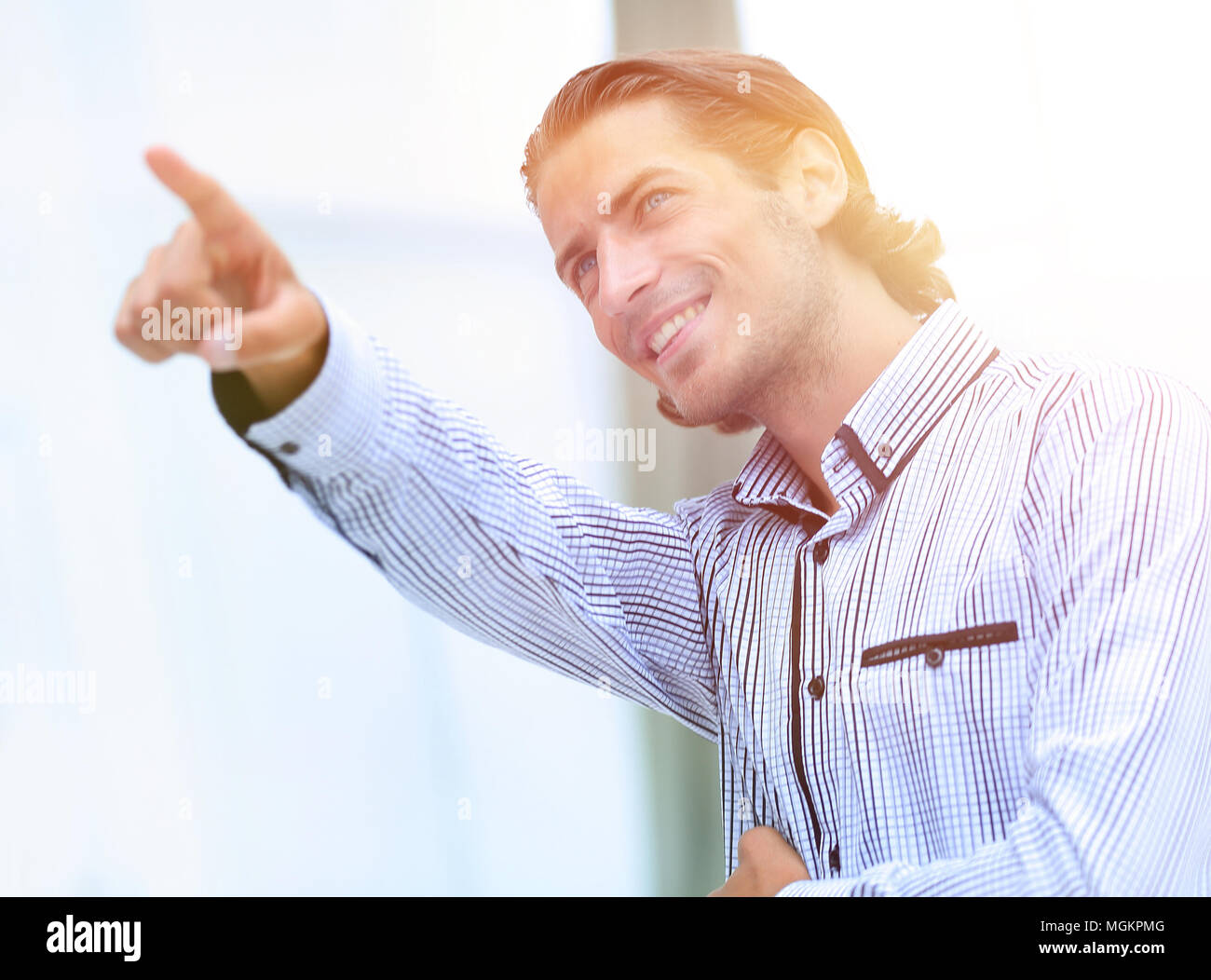 successful young man pointing forward Stock Photo - Alamy