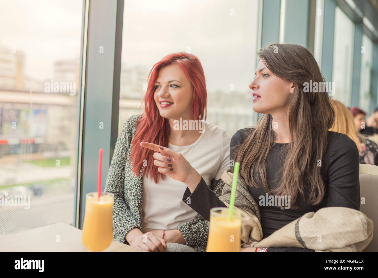 Three friends talking and having fun while drinking coffee hi-res stock ...