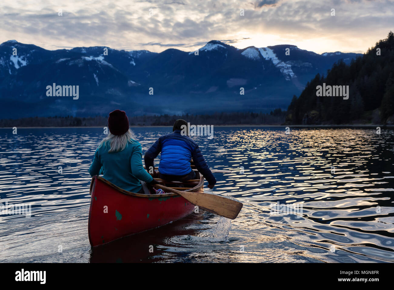 Adventurous people on a wooden canoe are enjoying the beautiful ...