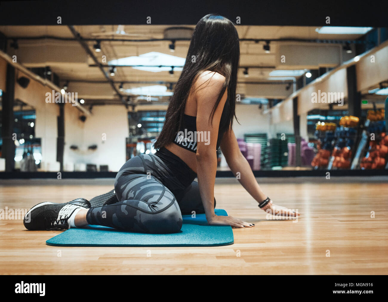 Young brunette girl stretching in gym Stock Photo - Alamy