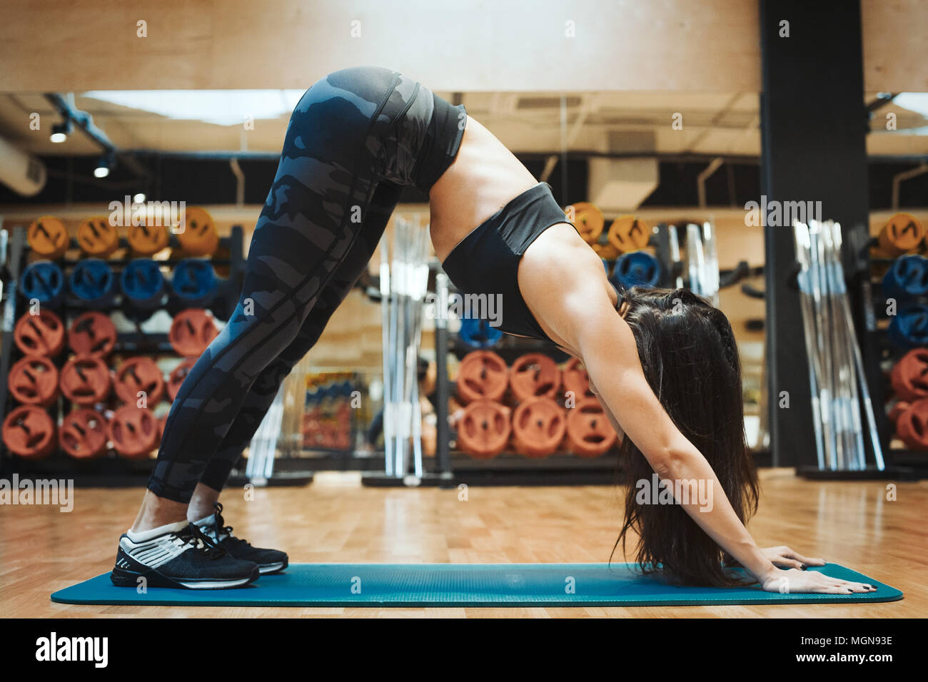 Young brunette girl stretching in gym Stock Photo - Alamy