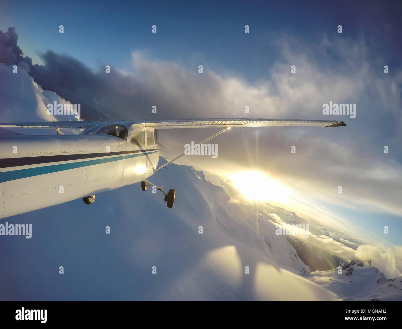 Small airplane flying over the Canadian Mountain Landscape during a ...