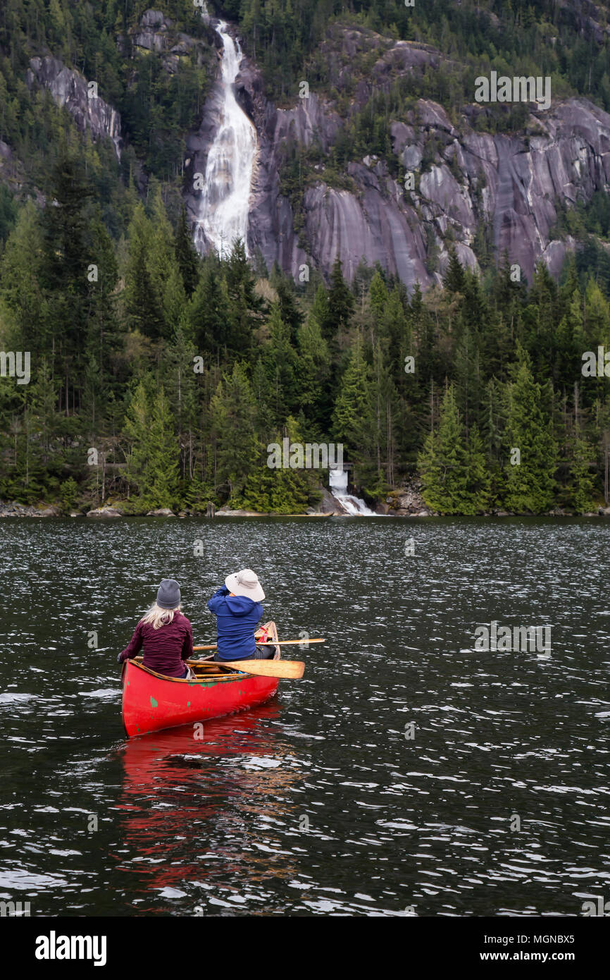 Couple adventurous people on a canoe are enjoying the beautiful ...