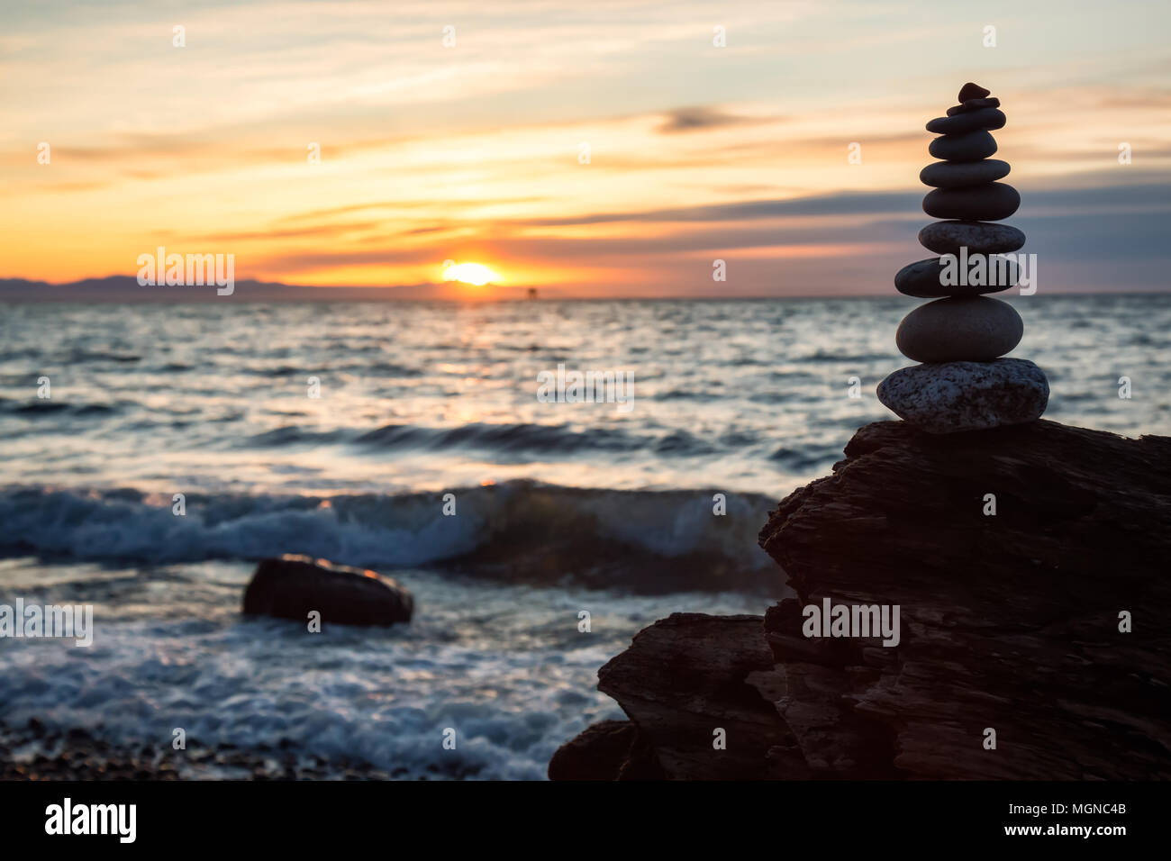 Stack of Rocks piled up by the ocean during a sunny sunset. Taken in ...