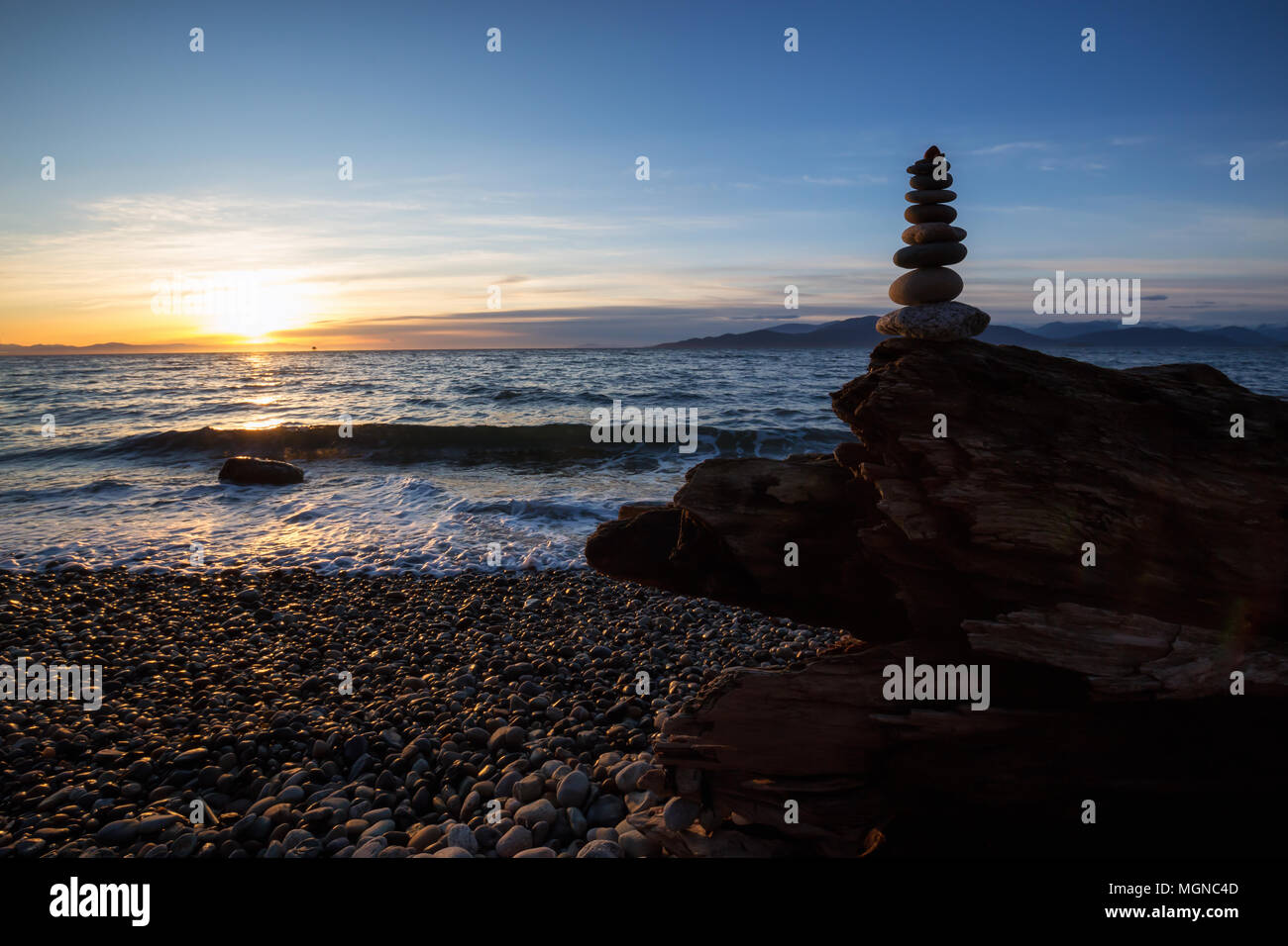 Stack of Rocks piled up by the ocean during a sunny sunset. Taken in ...