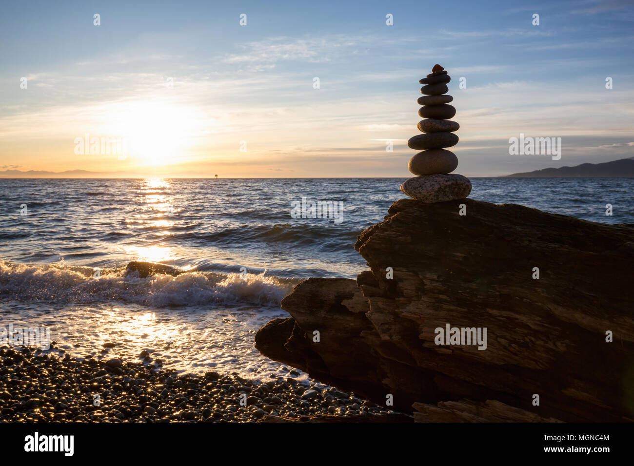 Stack of Rocks piled up by the ocean during a sunny sunset. Taken in ...