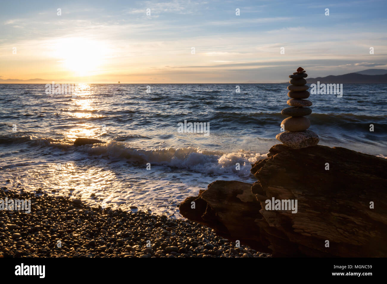 Stack of Rocks piled up by the ocean during a sunny sunset. Taken in ...