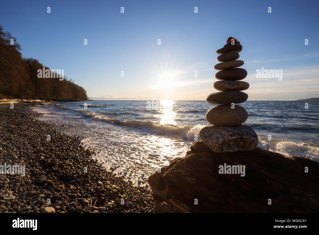 Stack of Rocks piled up by the ocean during a sunny sunset. Taken in ...