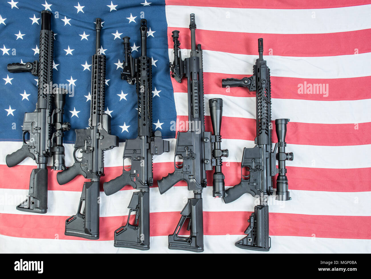 A collection of AR-15's on an American flag Stock Photo - Alamy