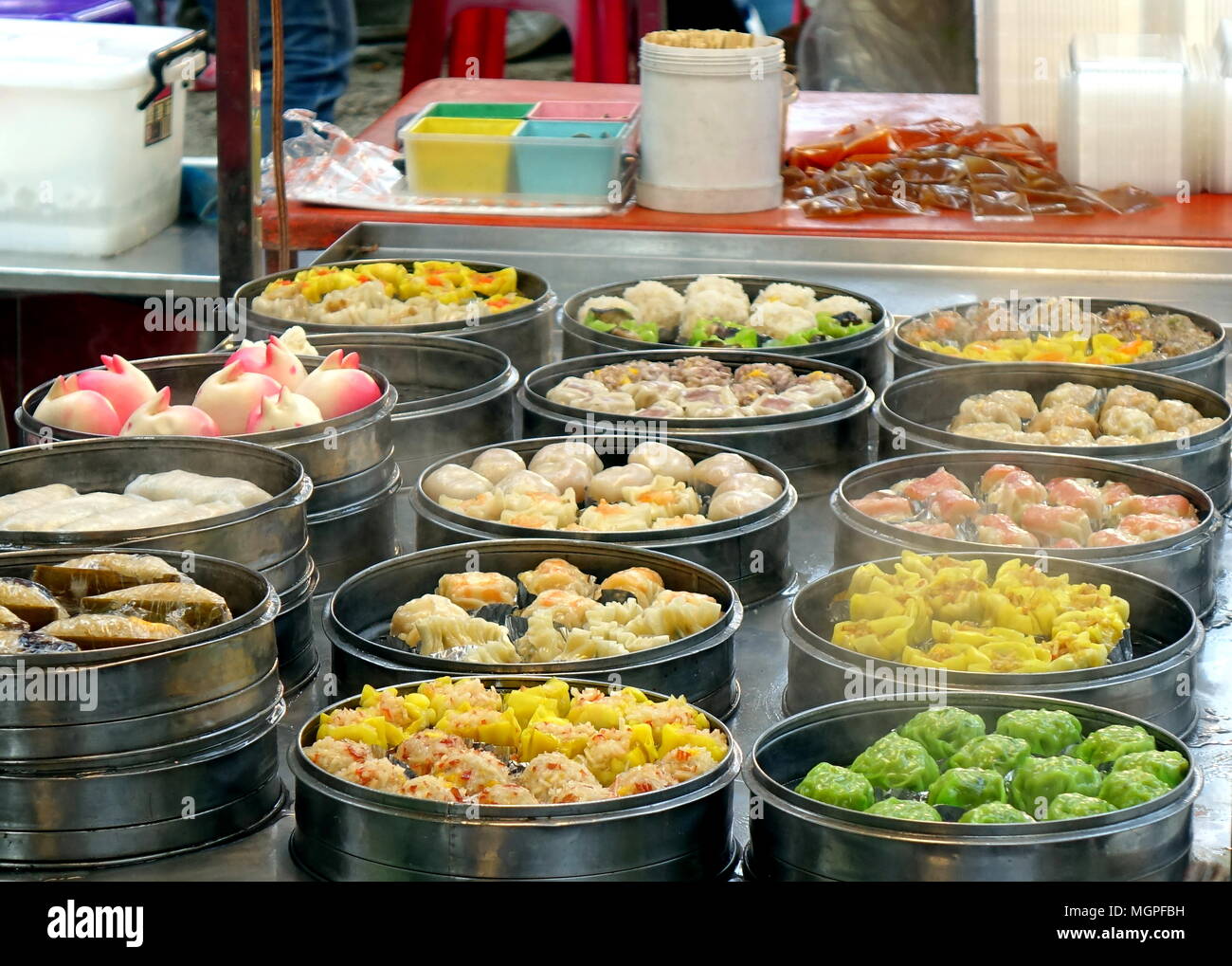 An outdoor vendor sells Cantonese Dim Sum dishes cooked in metal ...