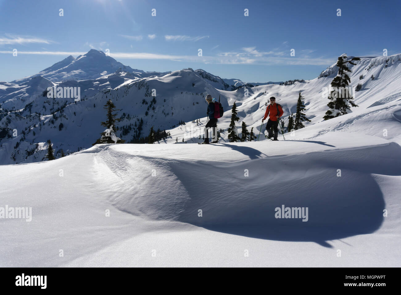 Adventurous man and woman are snowshoeing in the snow. Taken in Artist ...