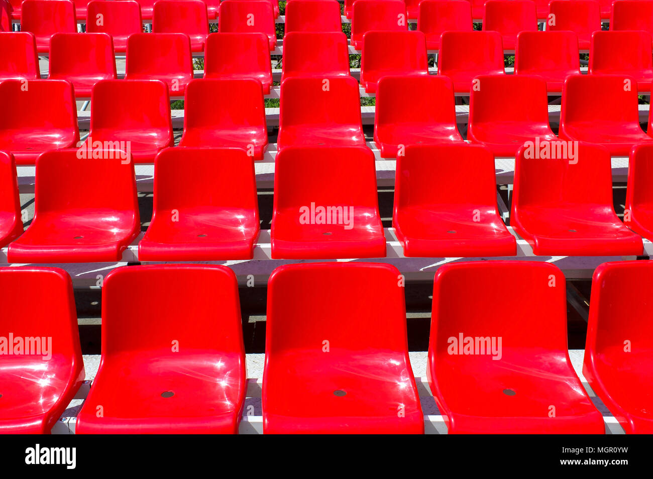 Spectator stands with red plastic seats in rows Stock Photo - Alamy