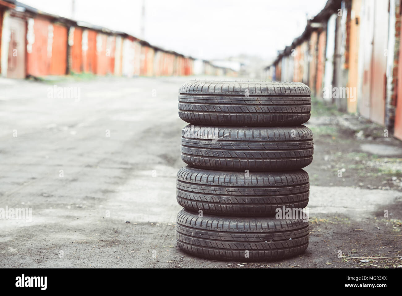 car tire with alloy wheel lies on the ground for a change on the car ...
