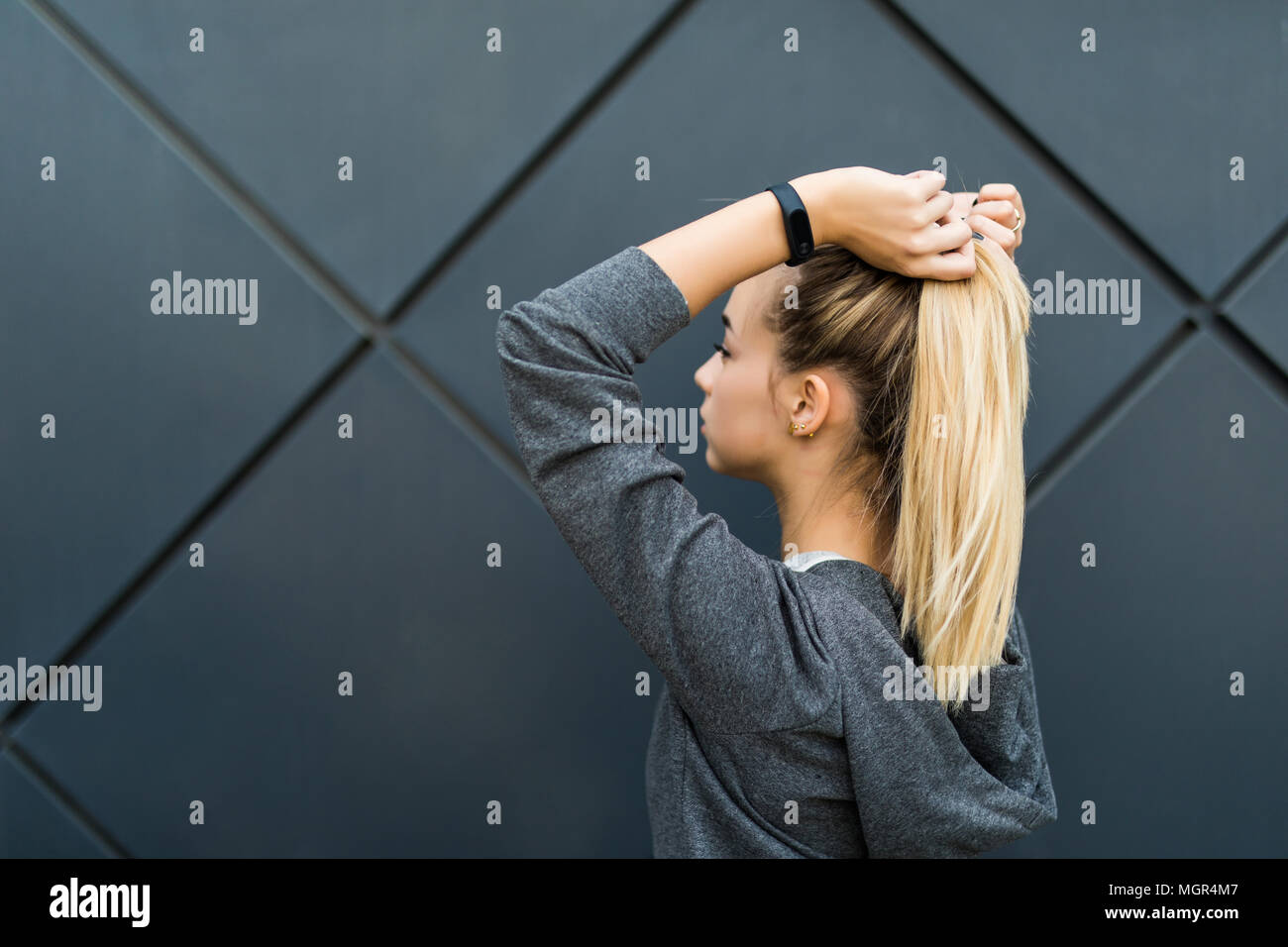 Sporty fitness woman lacing ponytail and getting ready for urban ...