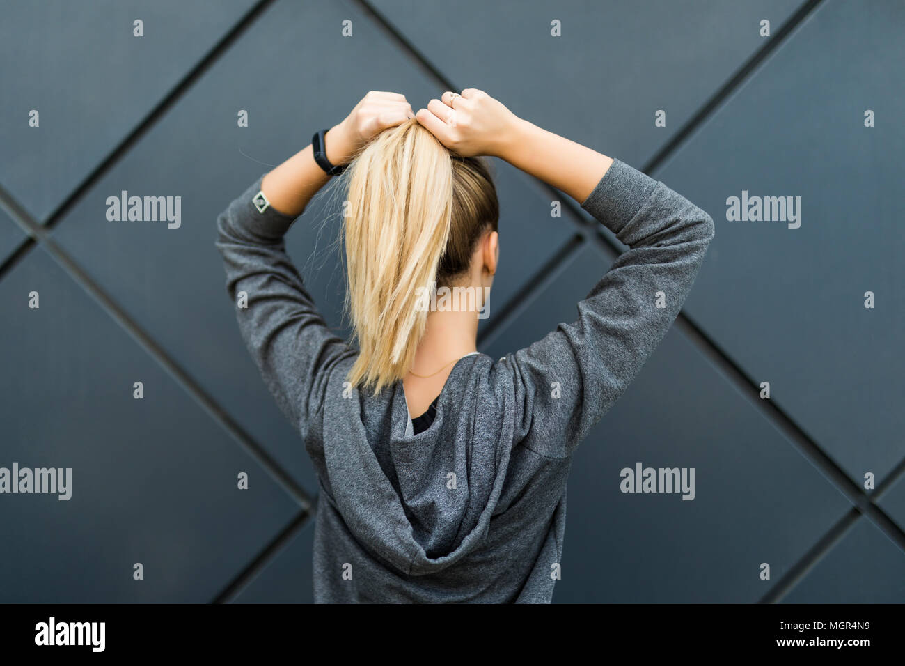 Sporty fitness woman lacing ponytail and getting ready for urban ...