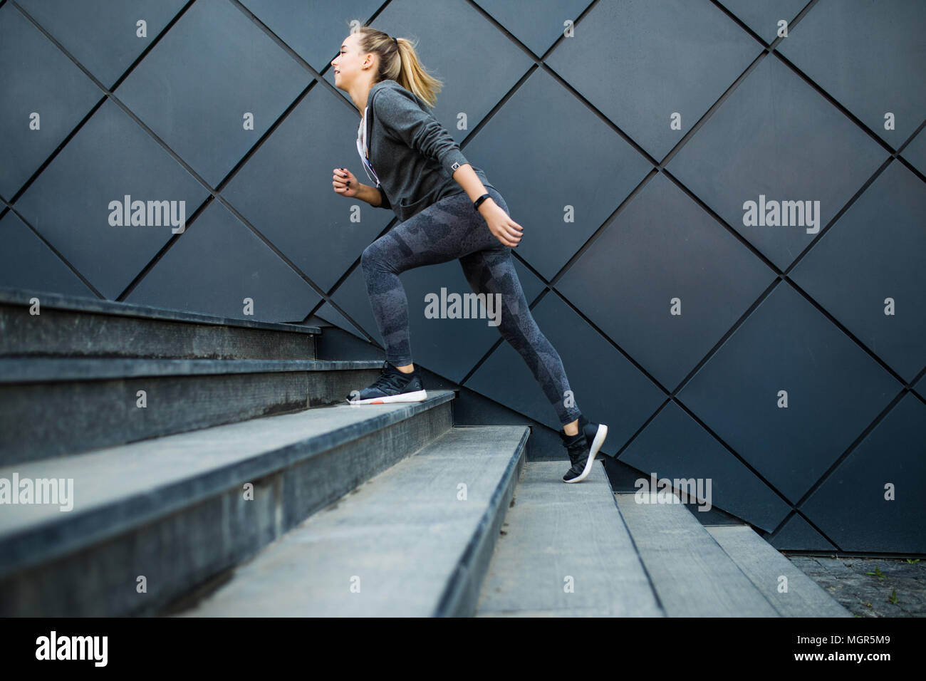 Girl runs fast on a modern stair Stock Photo - Alamy