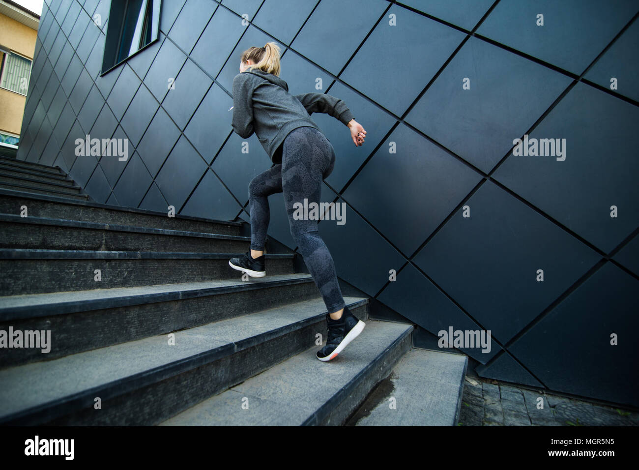 Black woman running up stairs hi-res stock photography and images - Alamy