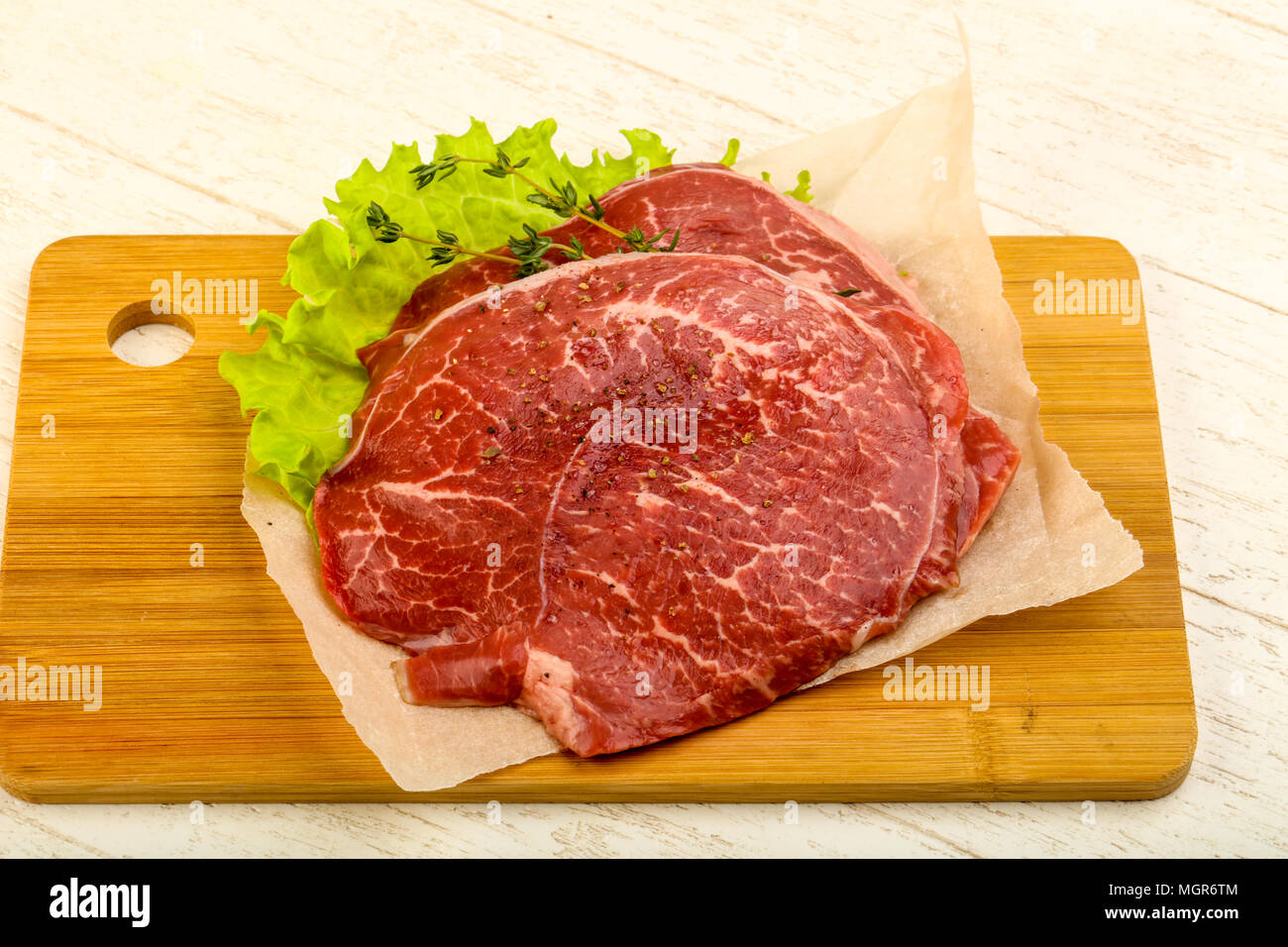 Raw beef schnitzel with spices ready for griil Stock Photo - Alamy