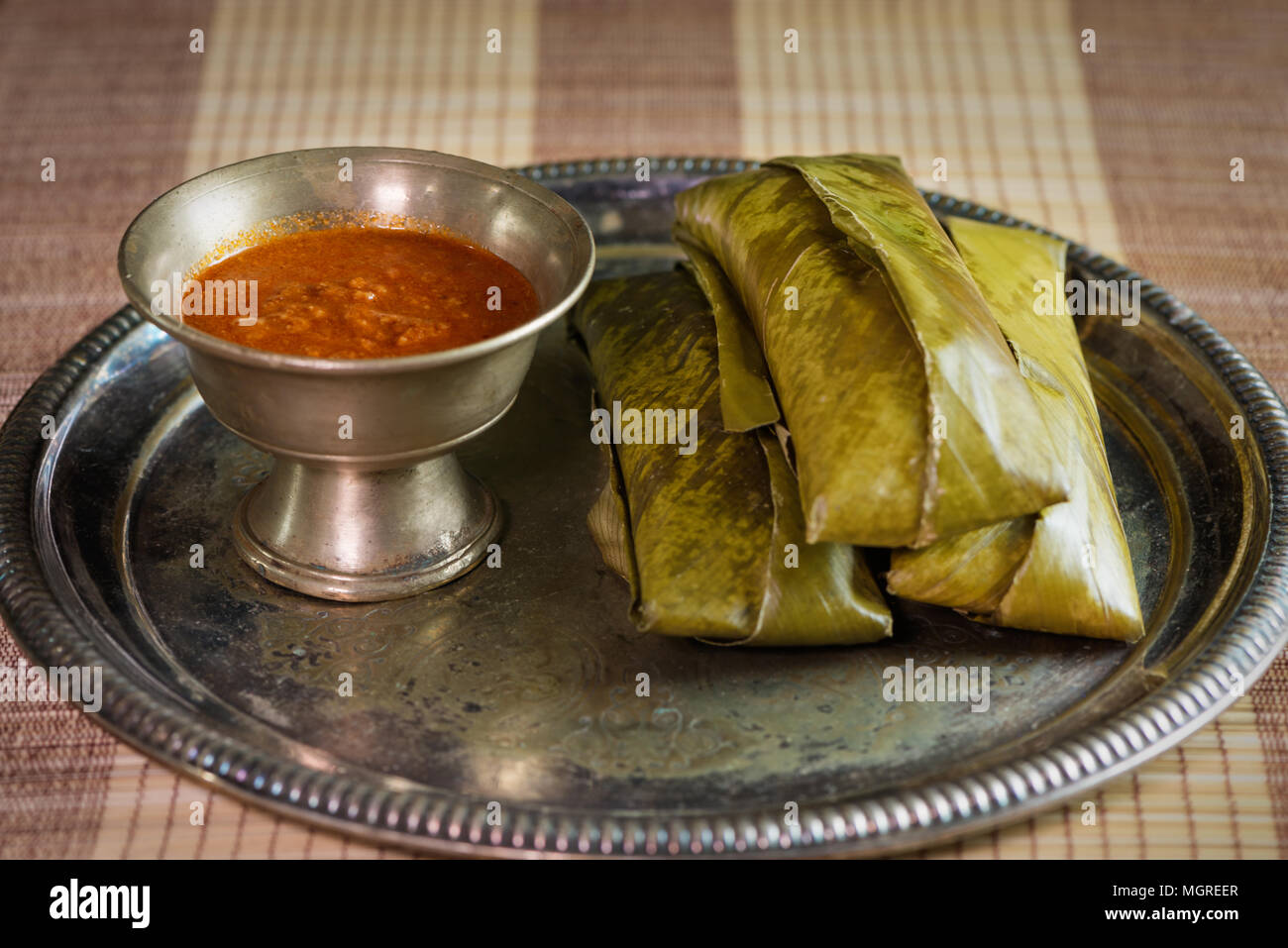 sticky rice wrapped in leaves and served with peanut sauce. Famous ...