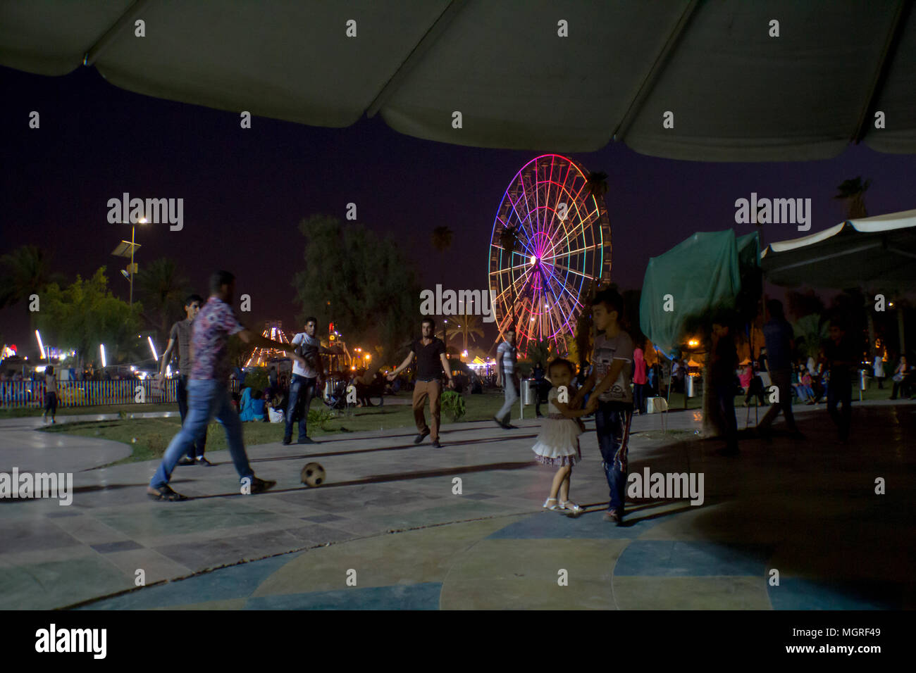 picture for Iraqi kids riding some games in Zawraa park in Baghdad city ...