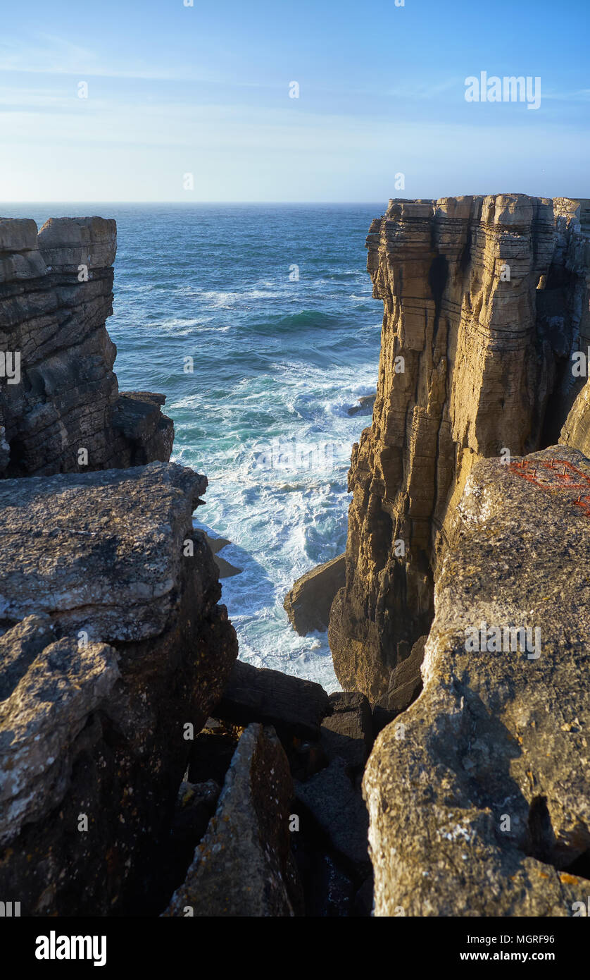 Rocks and waves of surf in the ocean near Cabo Carvoeiro (Cape of Coal ...