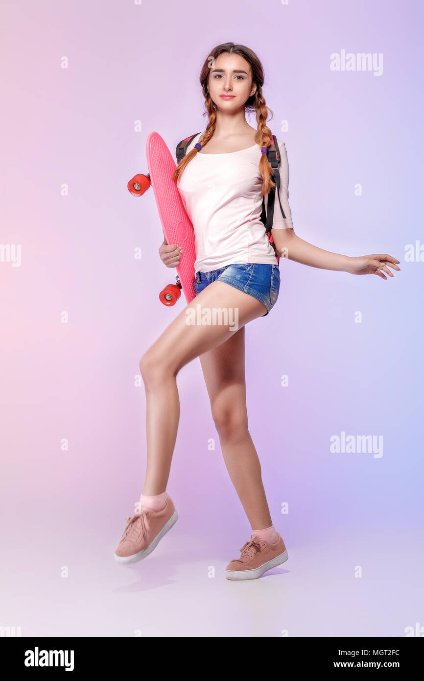 beautiful woman with skate in studio Stock Photo - Alamy