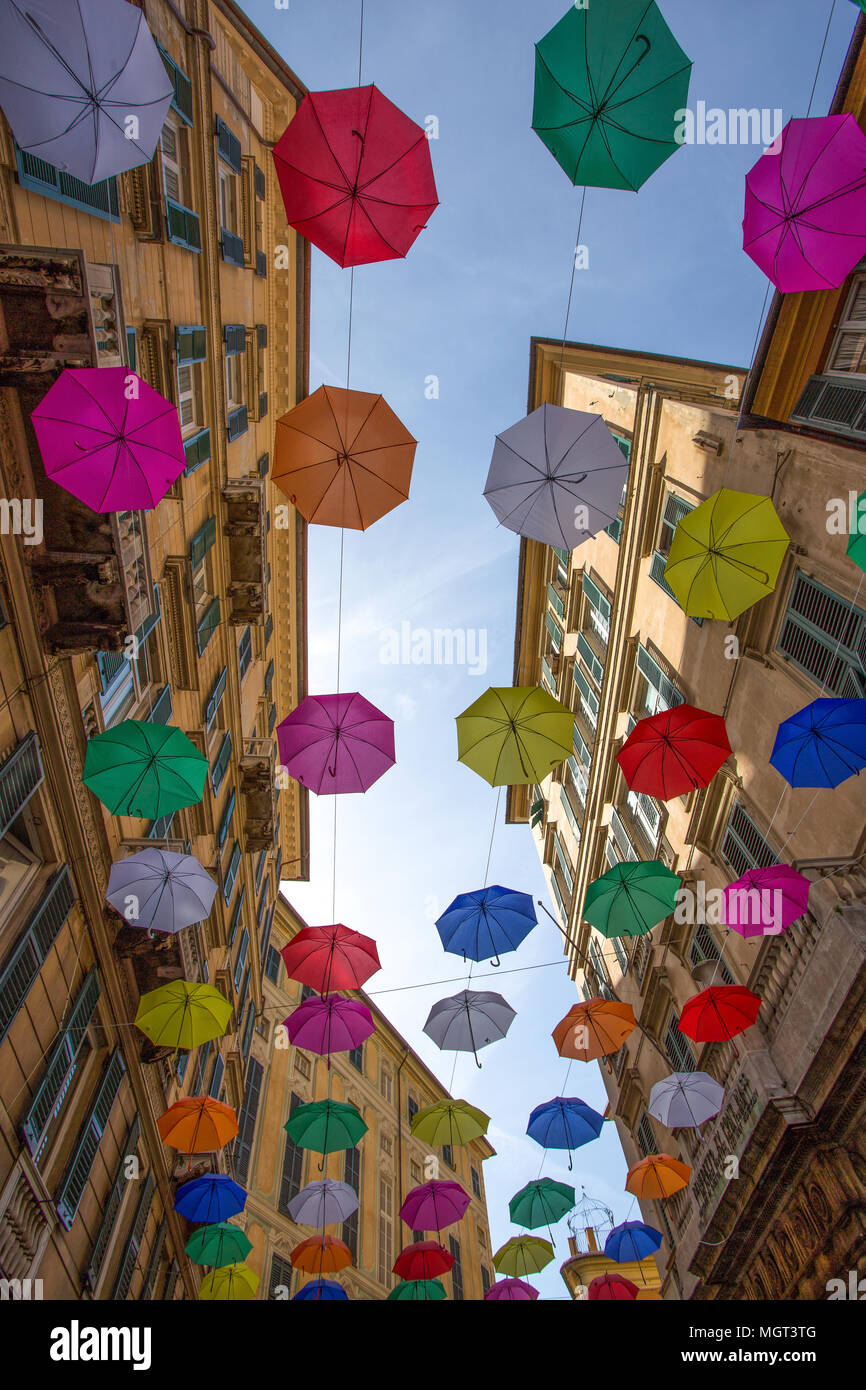 GENOA, ITALY, APRIL 16, 2018 - Multicolored umbrellas in the sky above ...