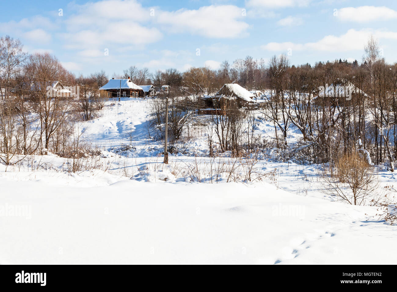 snow-covered little russian village in sunny winter day in Smolensk ...